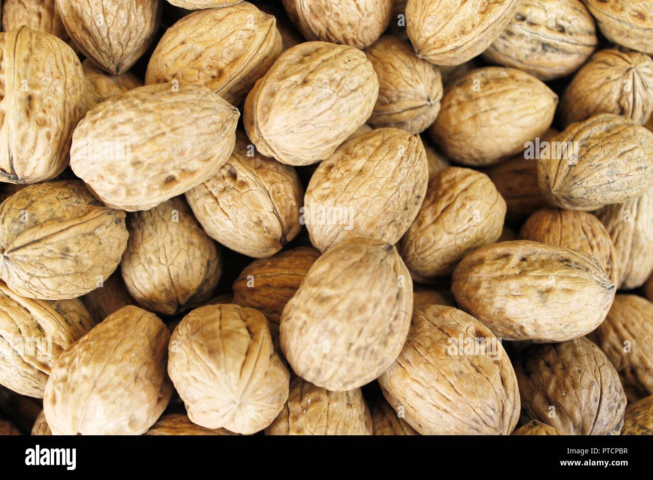 Crude walnut with nutshell for background of texture Stock Photo - Alamy