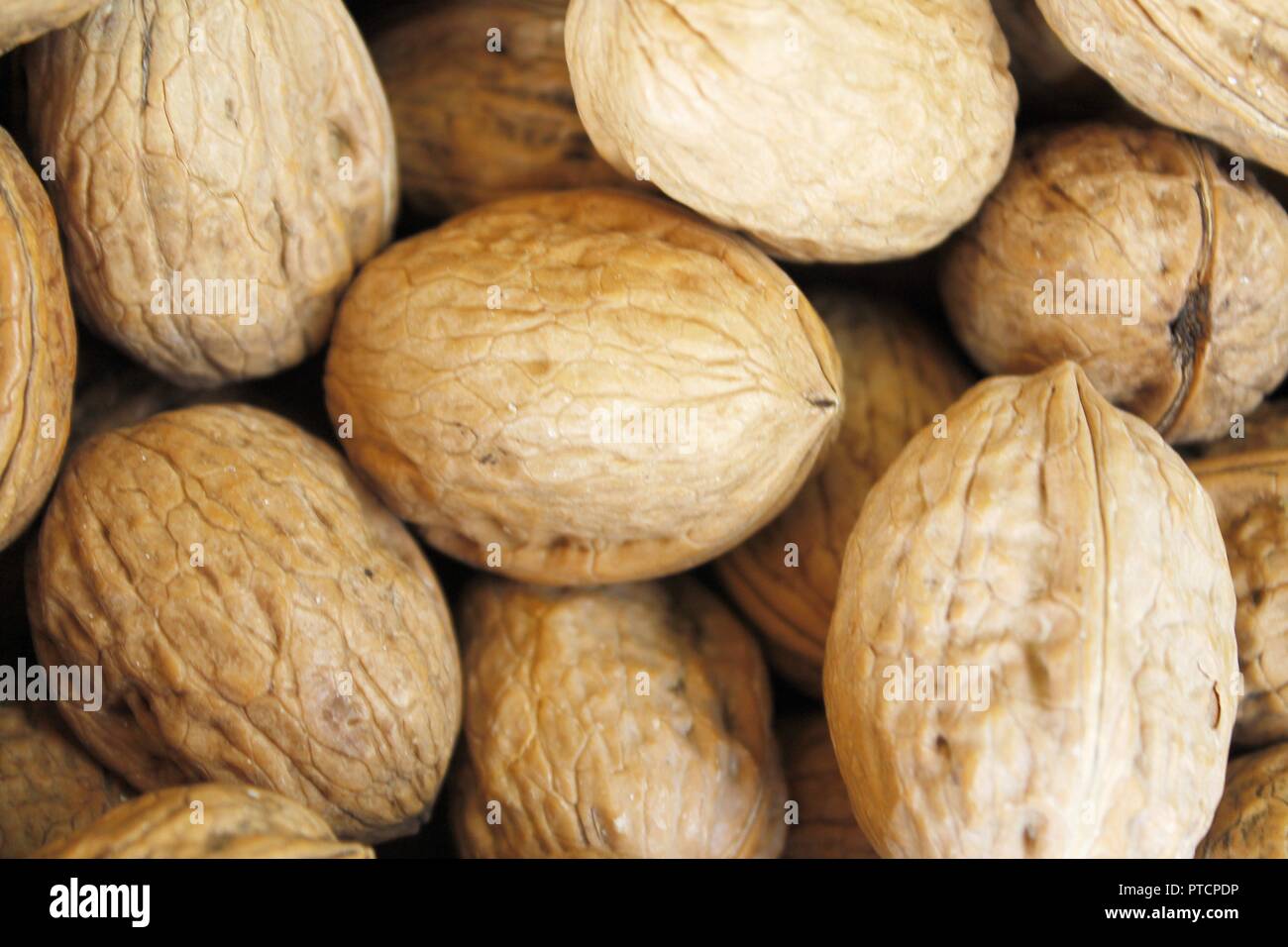 Crude walnut with nutshell for background of texture Stock Photo - Alamy
