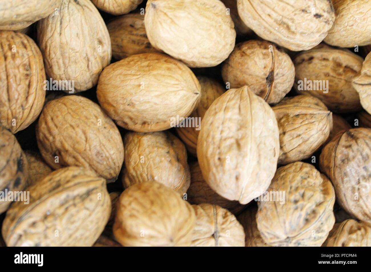 Crude walnut with nutshell for background of texture Stock Photo - Alamy
