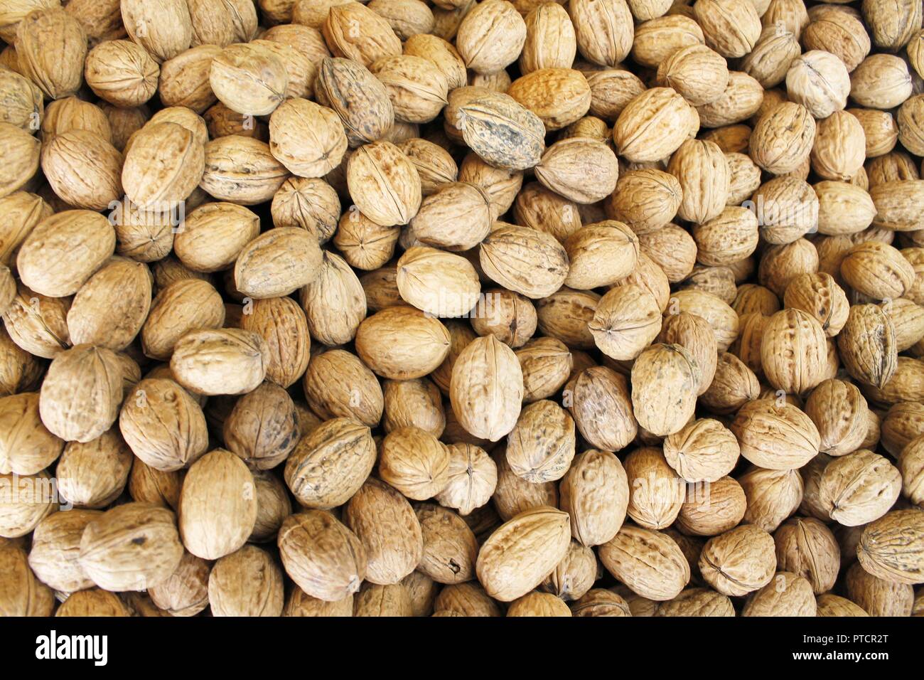 Crude walnut with nutshell for background of texture Stock Photo - Alamy