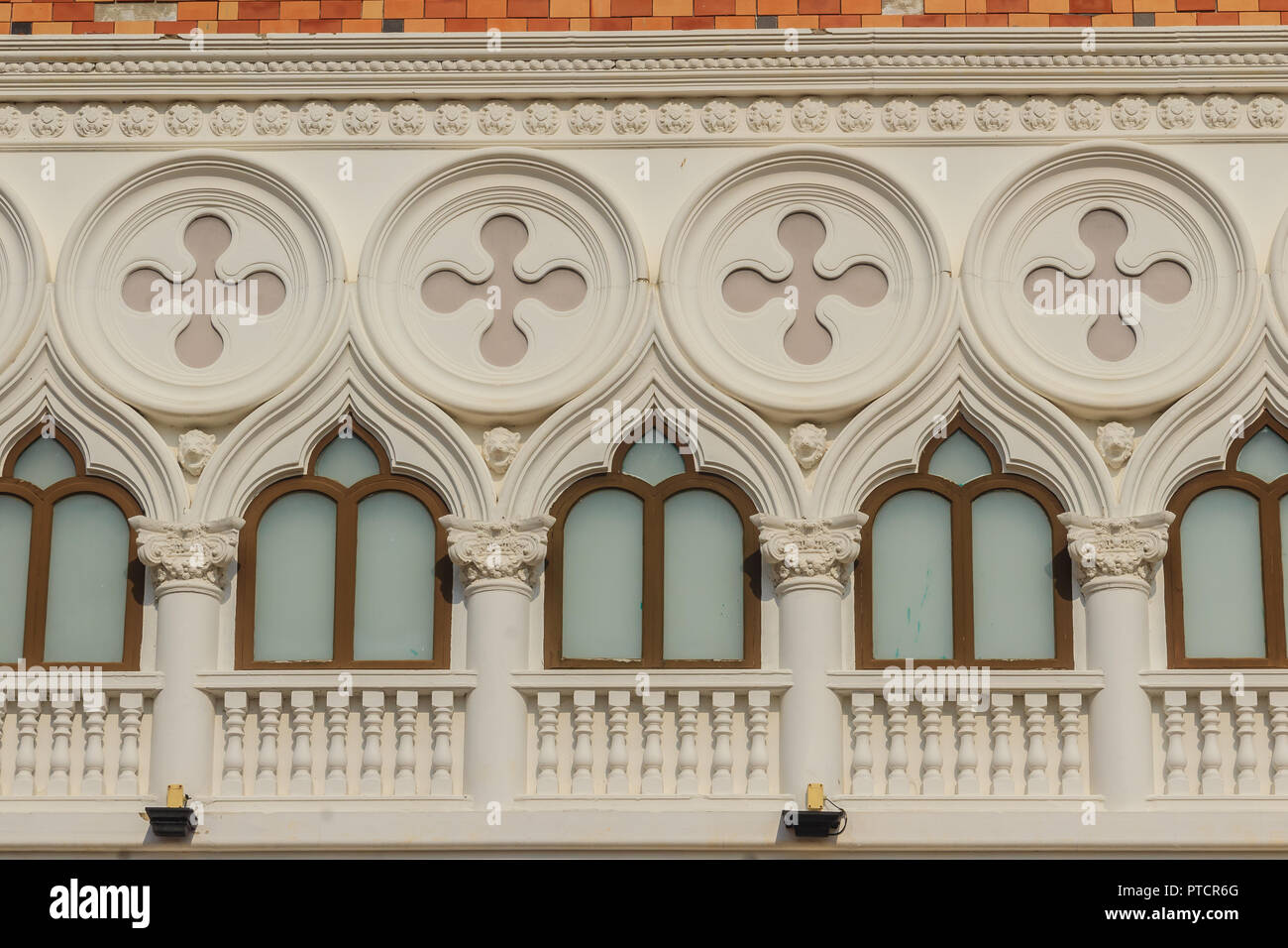 Abstract French balconies which decorated in circle shape above arch ...