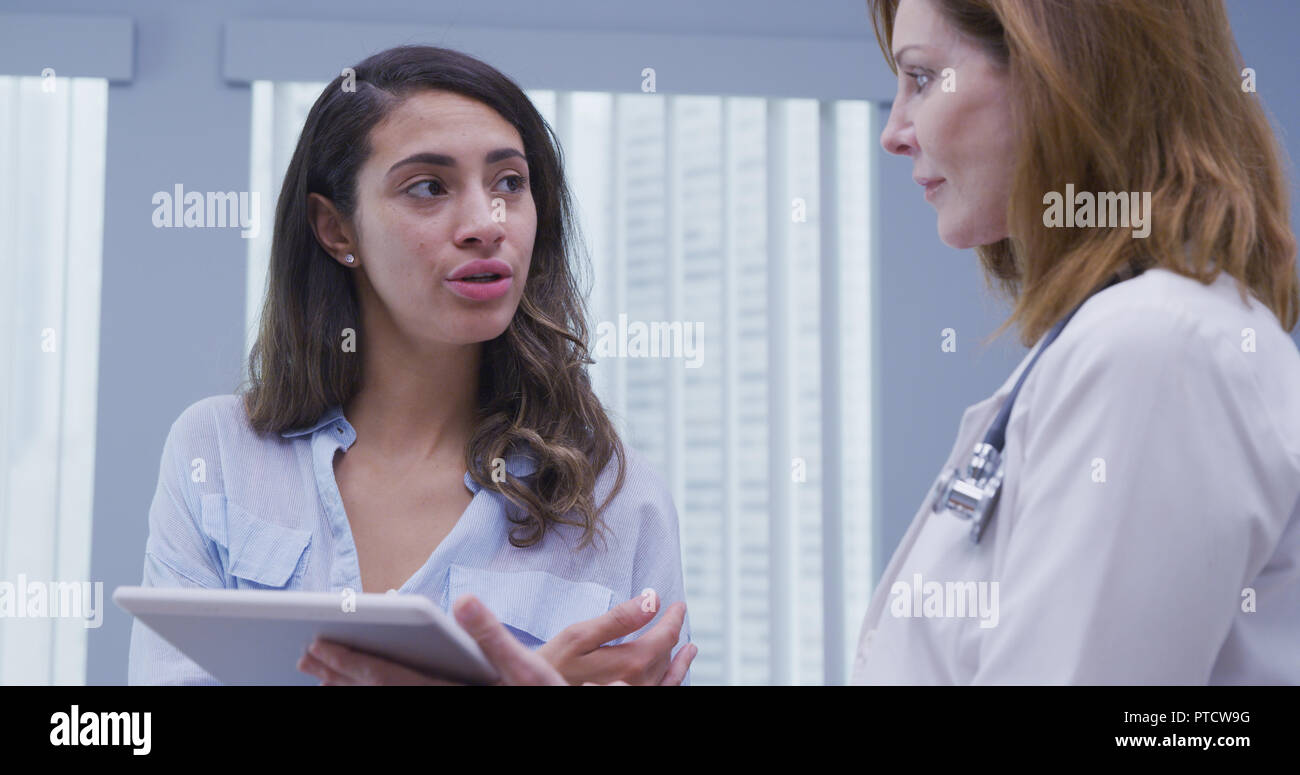 Close up portrait of young latina patient meeting with doctor about ...