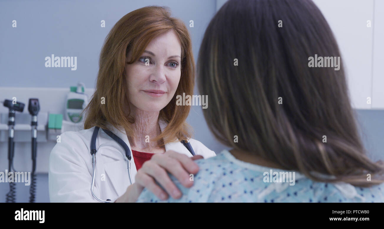 Happy doctor telling patient to be positive after having accident Stock ...