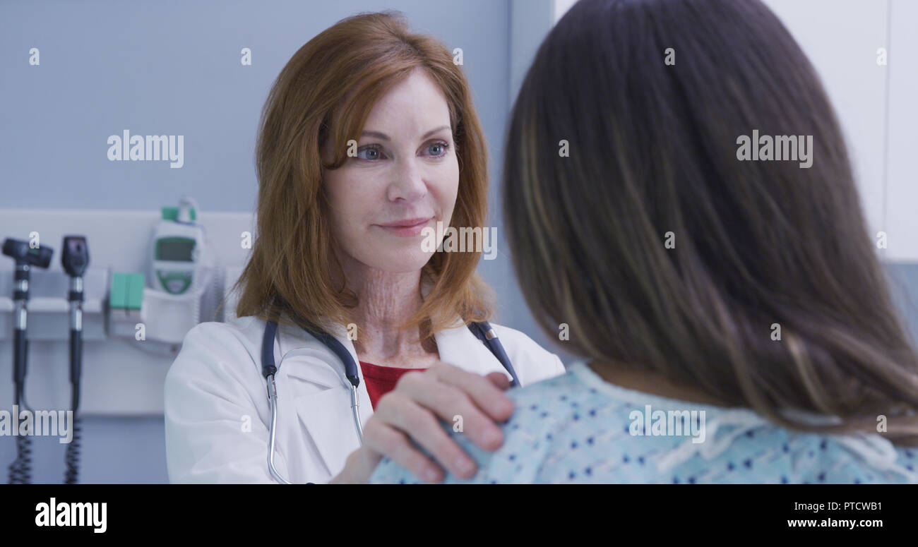 Happy doctor telling patient to be positive after having accident Stock ...