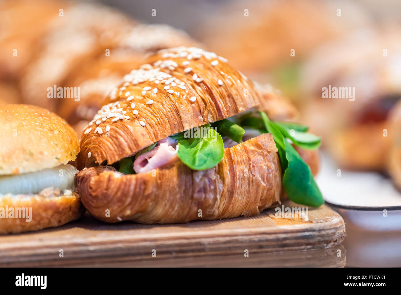 Closeup of savory breakfast croissant sandwich golden dessert in bakery ...