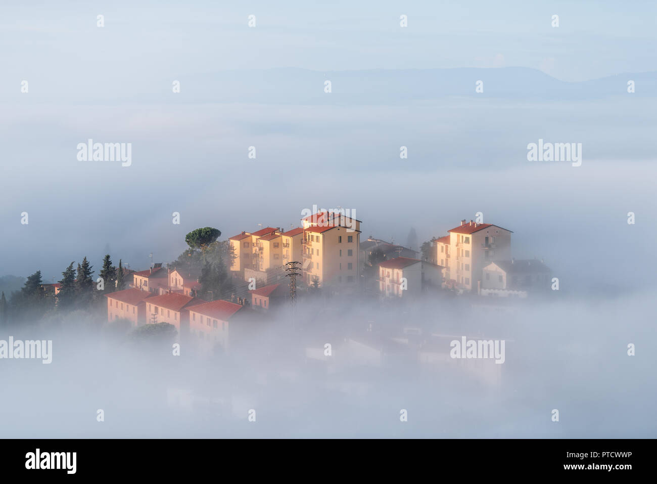 Chiusi Scalo mist fog sunrise of rooftop houses buildings in Umbria ...