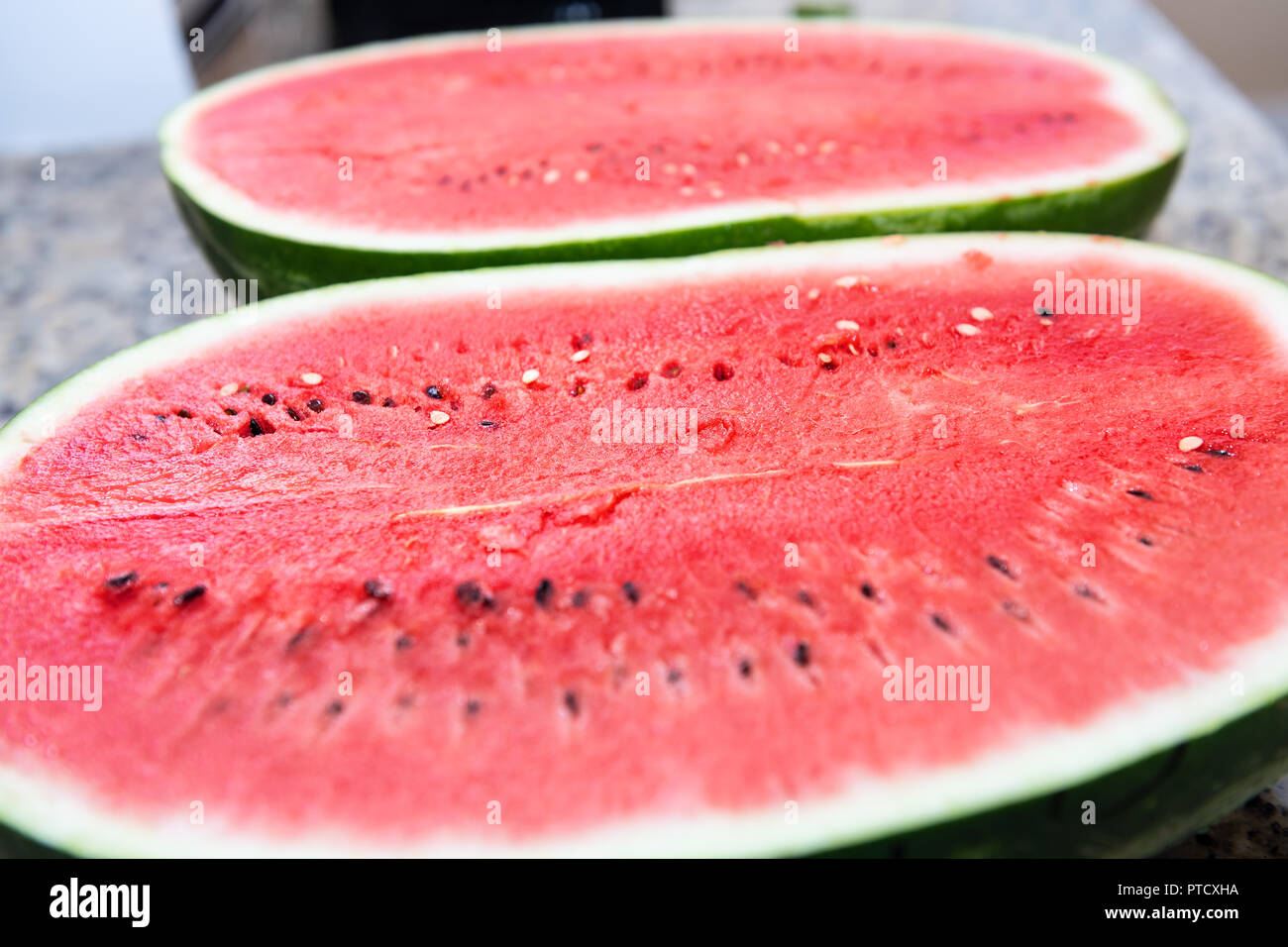 Closeup of two halfs, halves of red watermelon cut in half with seeds ...