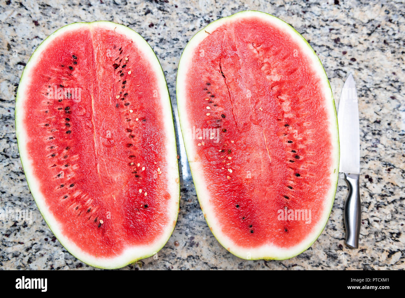 Closeup table lay flat top view of two halfs, halves of red watermelon ...