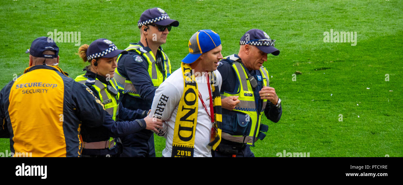 Police arresting and escorting a pitch invader at the 2018 AFL Grand ...