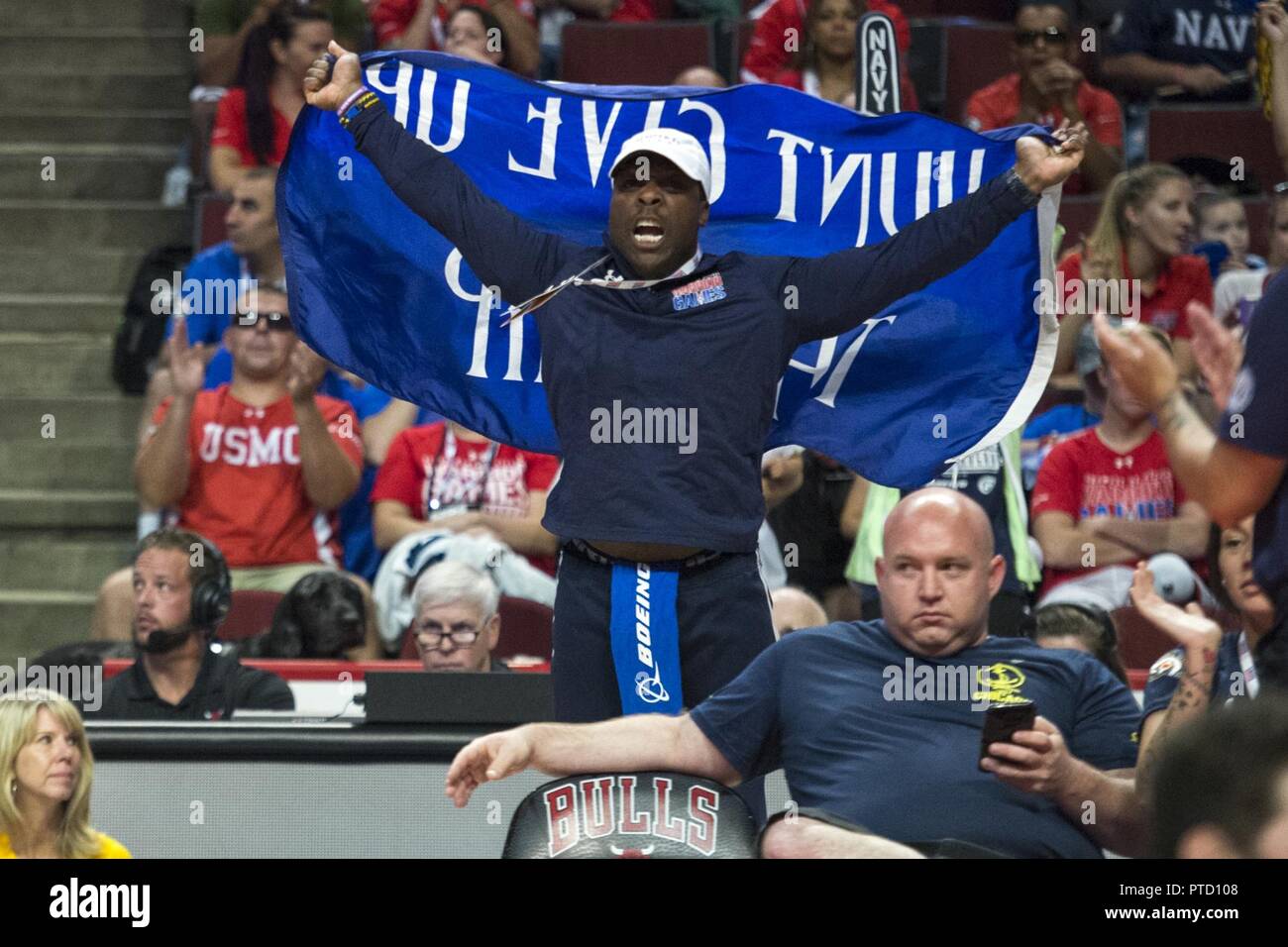 Navy Sports Coordinator Jason Youngblood cheers on Team Navy during the ...