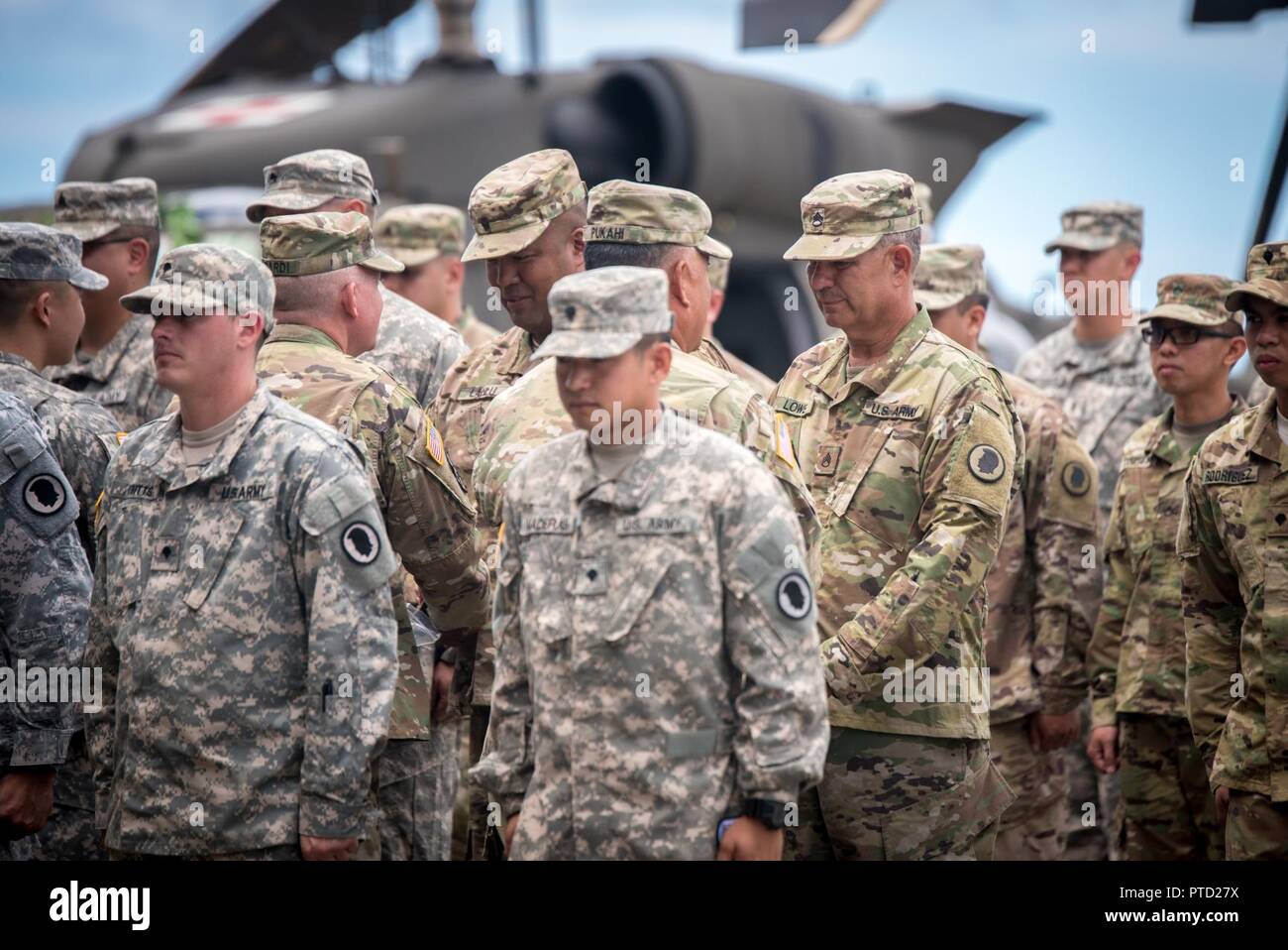 Col. Roger T. Pukahi hands a Non-Commissioned Officer a patch at 1 ...