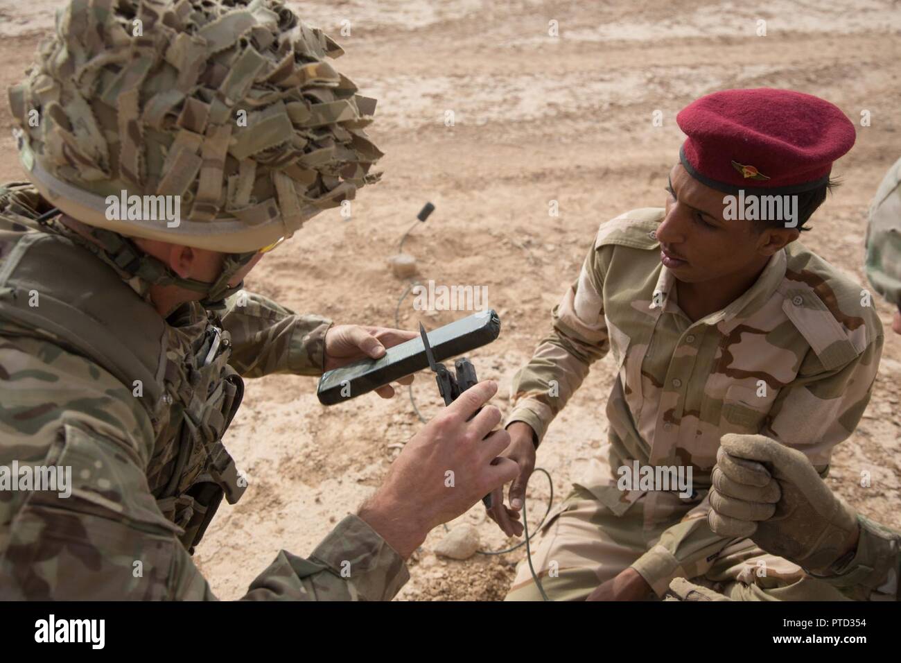 British trainer Sgt. Butch mentors an Iraqi soldier on how to prepare a ...