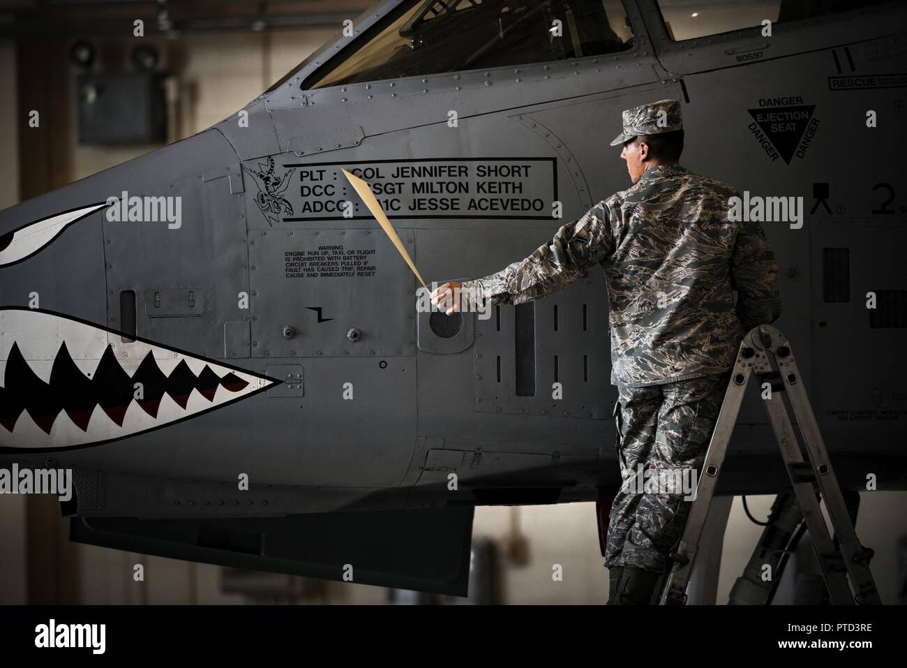 Airman 1st Class Jesse Acevedo, 75th Aircraft Maintenance Unit crew chief, reveals a name plate ...