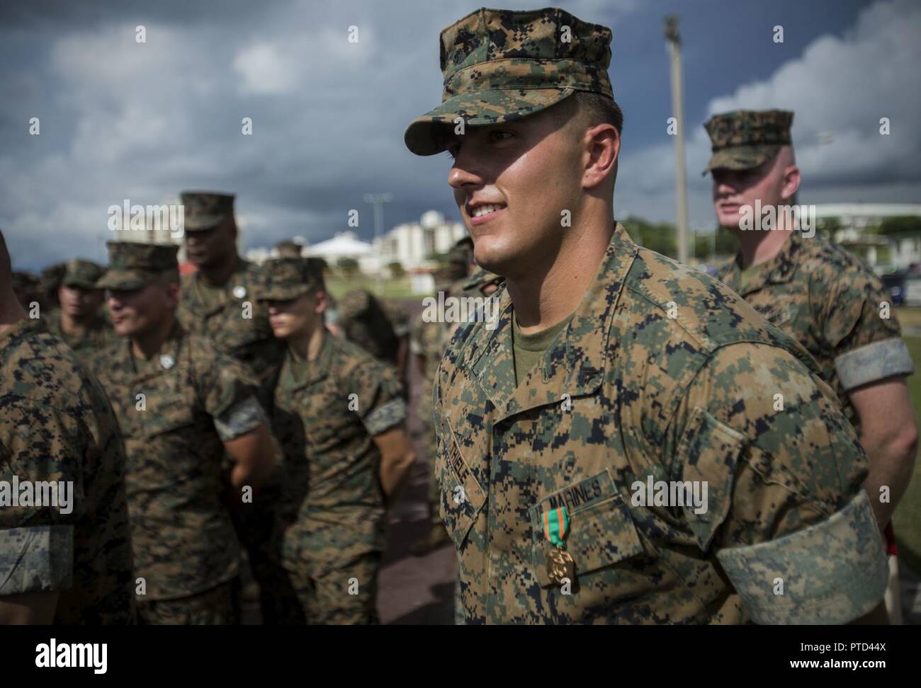 U.S. Marine Cpl. Otto Thiele receives a Navy Achievement Medal from Col ...