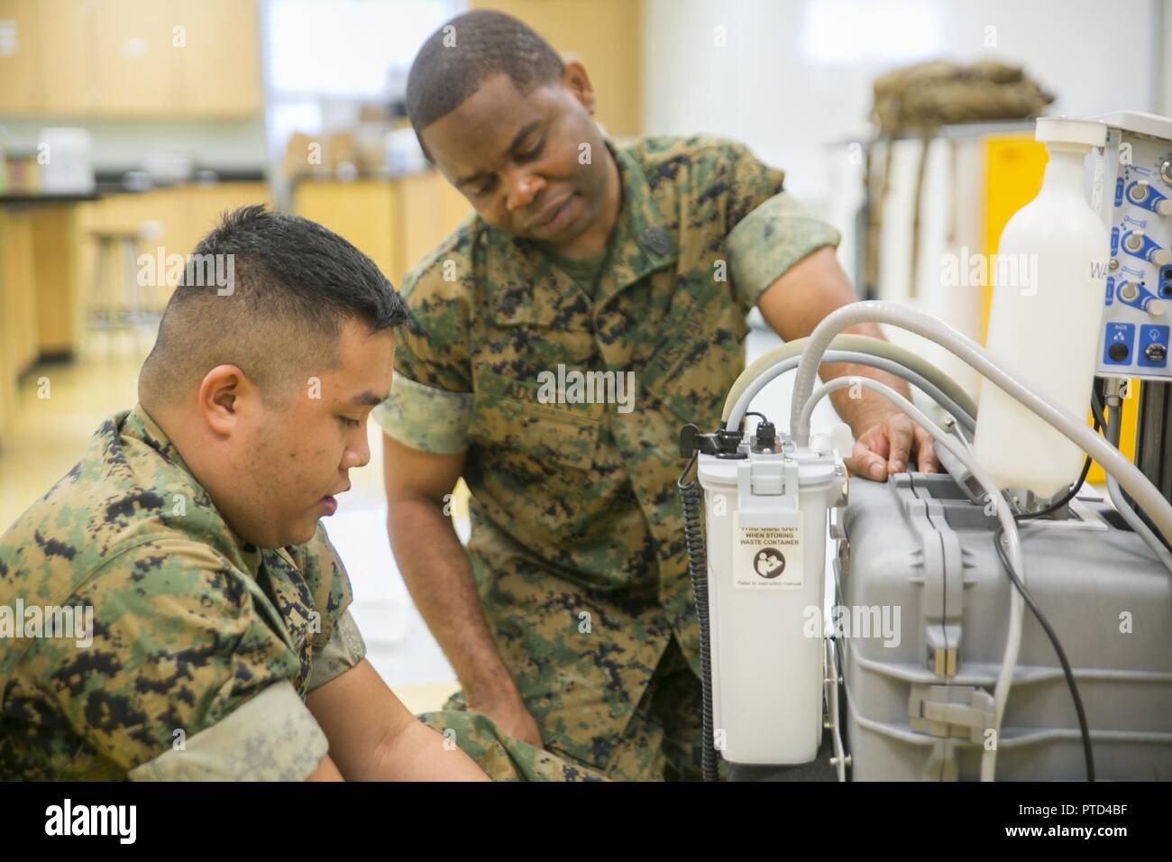 Petty Officer 2nd Class John Lagmay (left) and Petty Officer 3rd Class ...