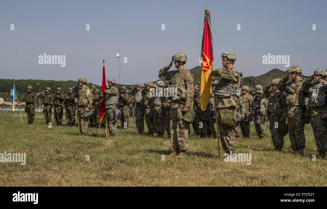 US and Romanian soldiers salute during the playing of each country’s ...