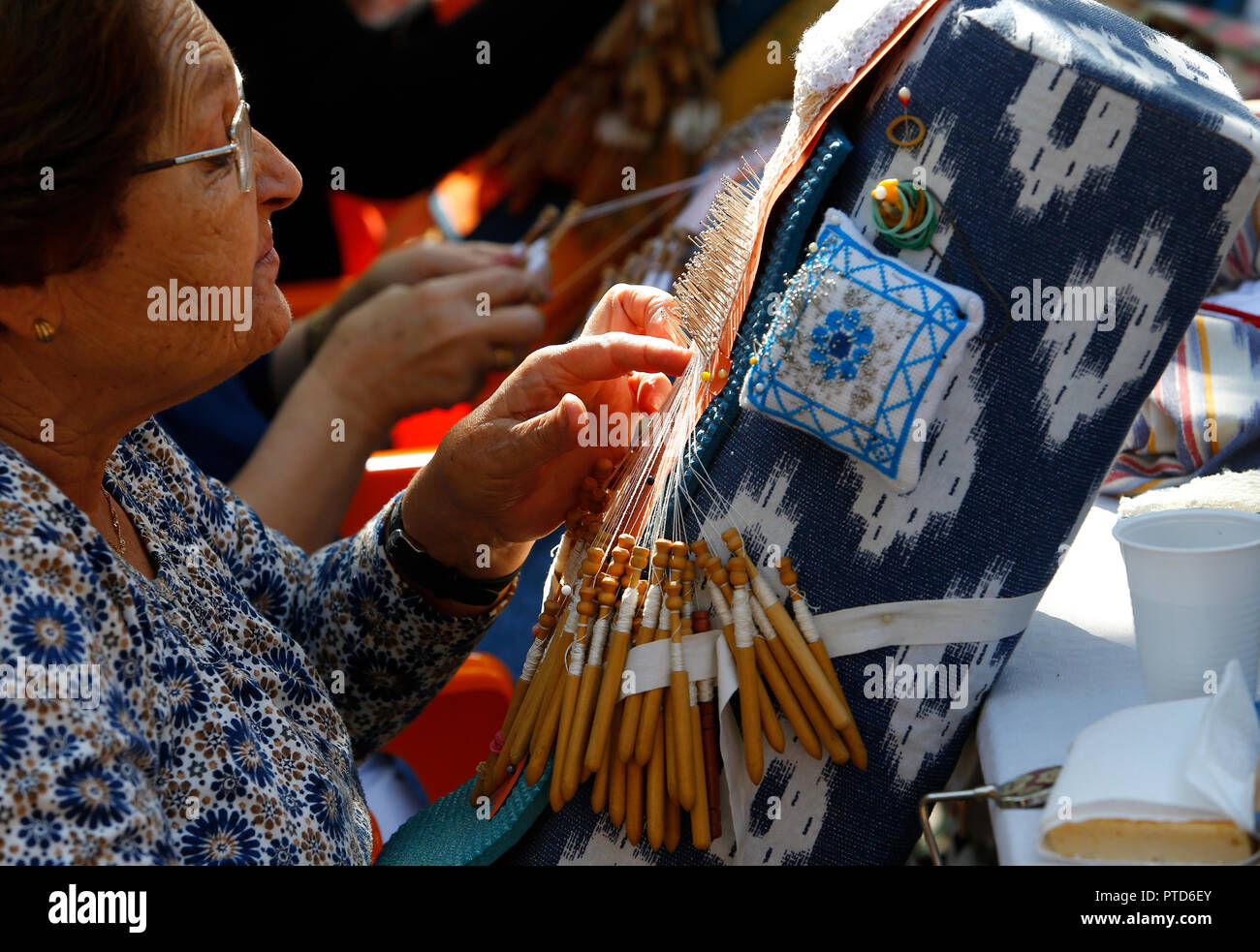 Bobbin lace weaver woman showing her traditional handmade technique ...