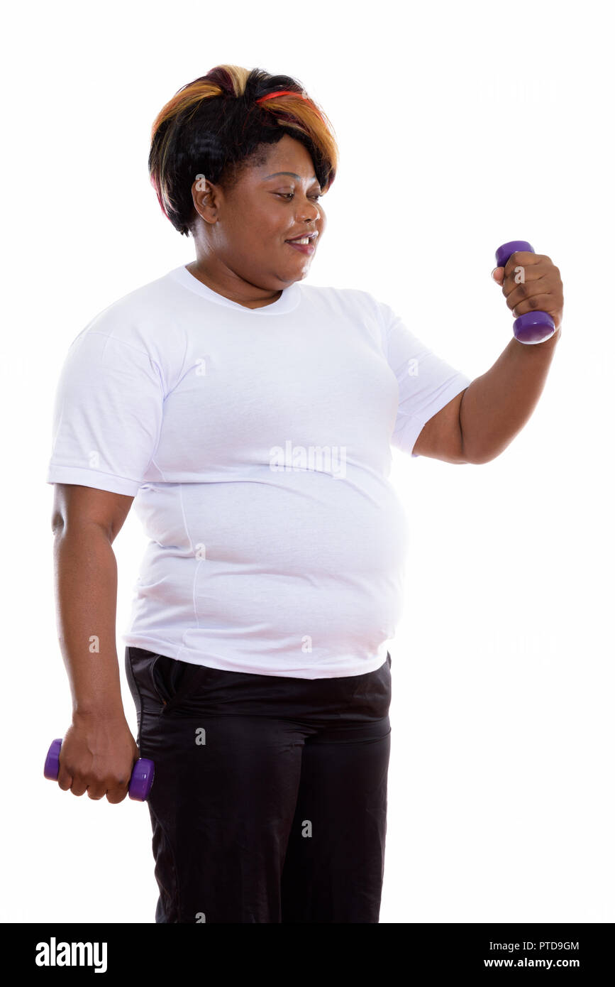 Profile view of happy fat black African woman smiling while rais Stock ...