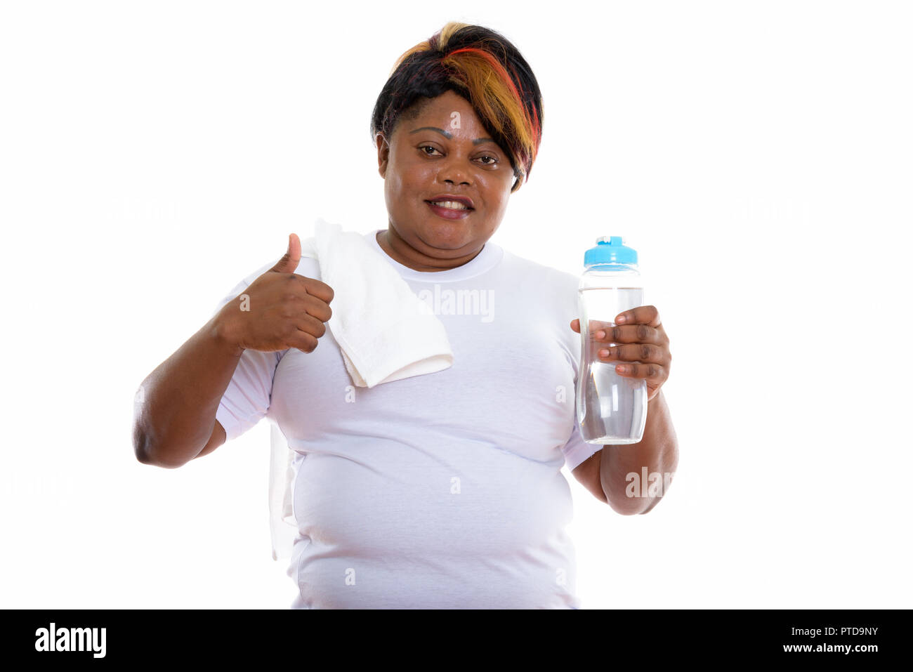 Happy fat black African woman smiling while holding water bottle Stock ...