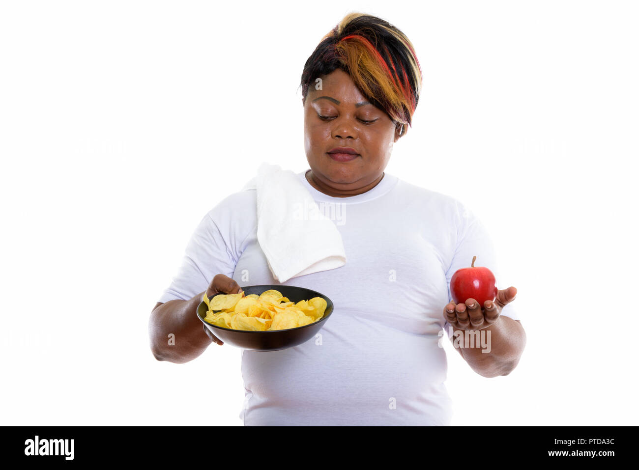 Studio shot of fat black African woman looking at bowl of potato Stock ...