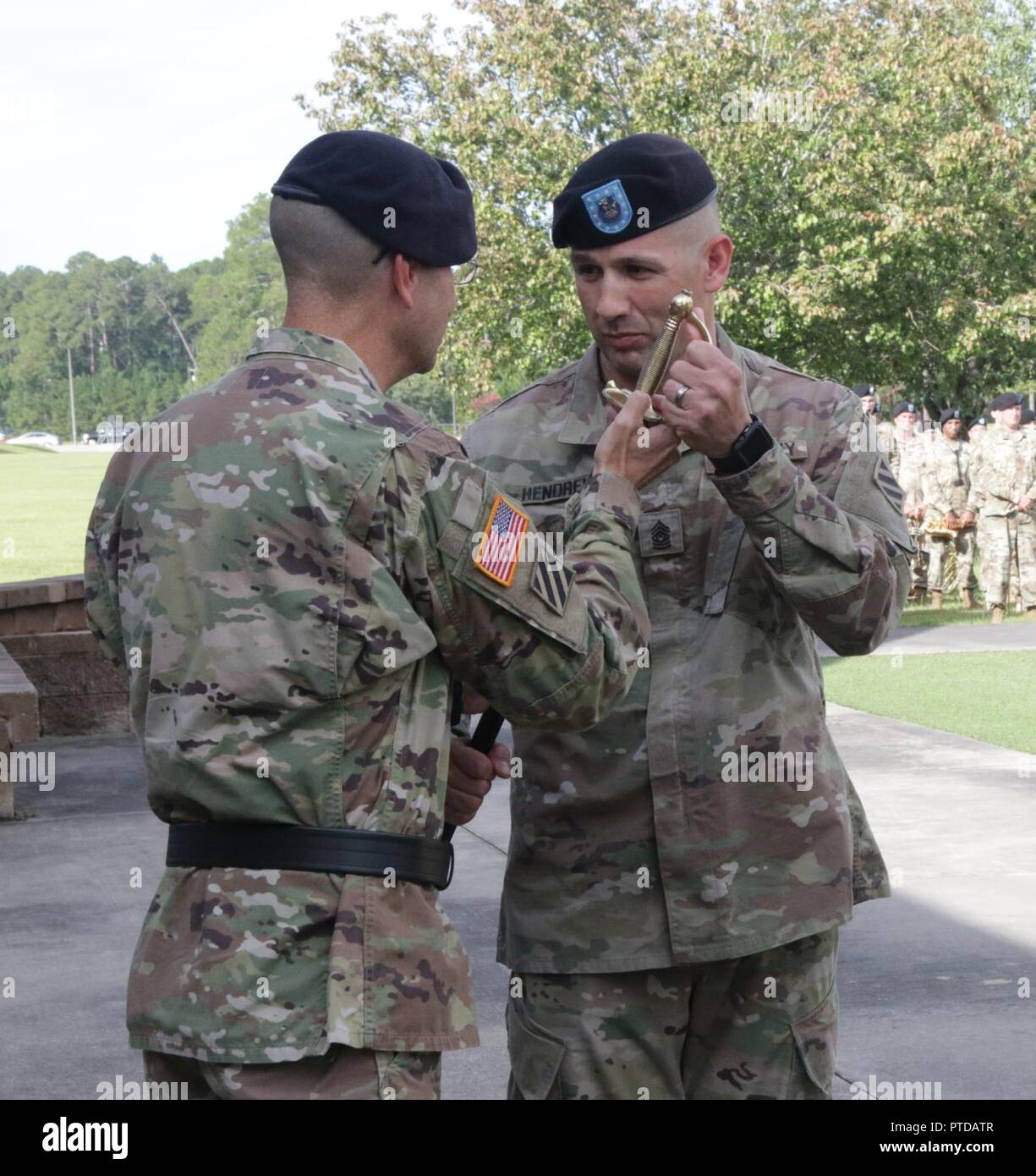 Maj. Gen. Leopoldo A. Quintas Jr. passes the noncommissioned officer's ...