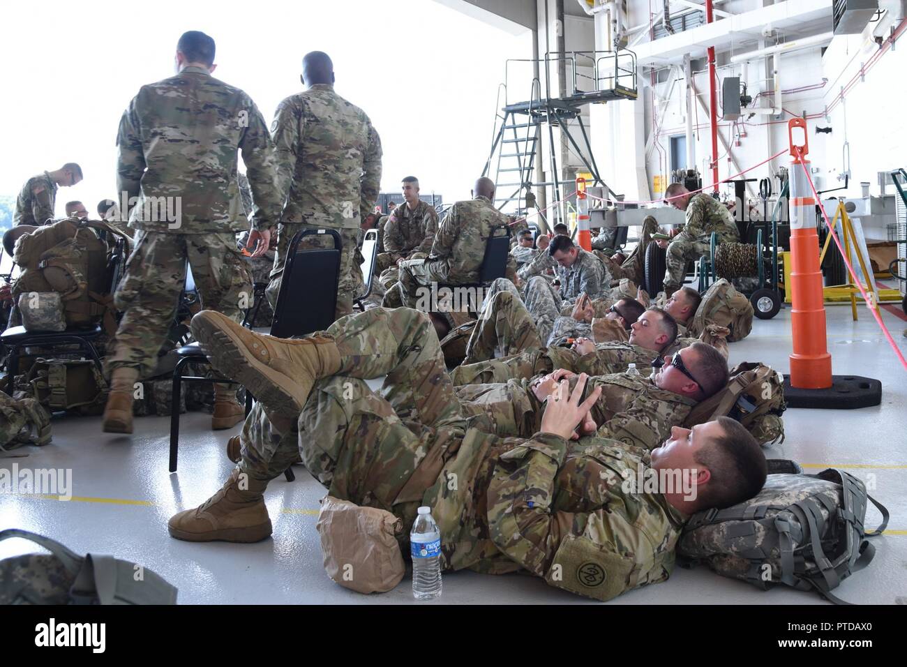A New York Army National Guardsman passes the time while waiting to be ...