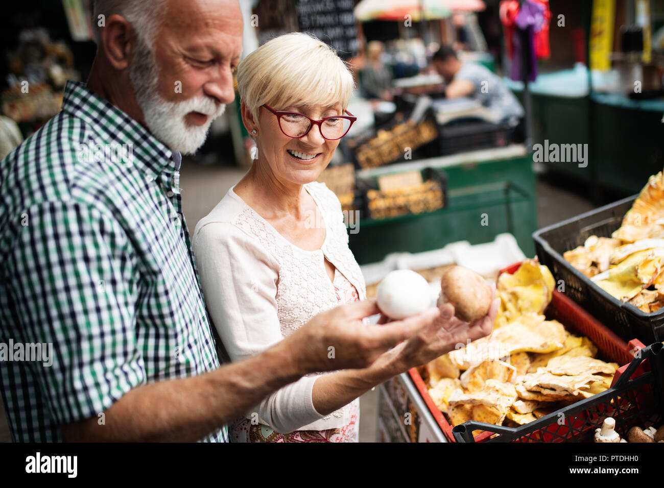 Only the best fruits and vegetables. Beautiful senior couple buying ...