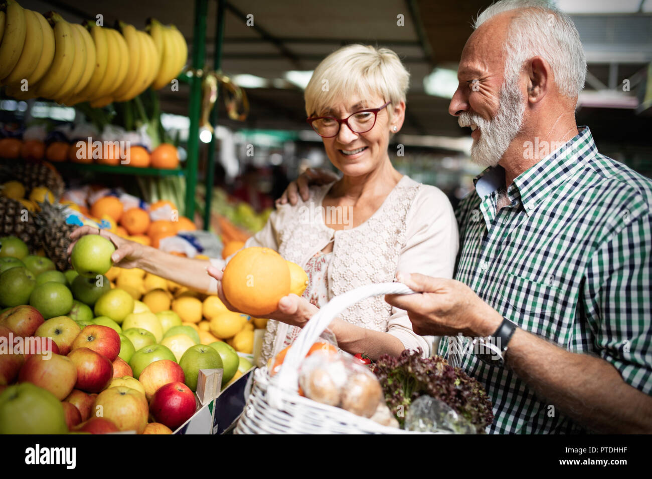 Only the best fruits and vegetables. Beautiful senior couple buying ...
