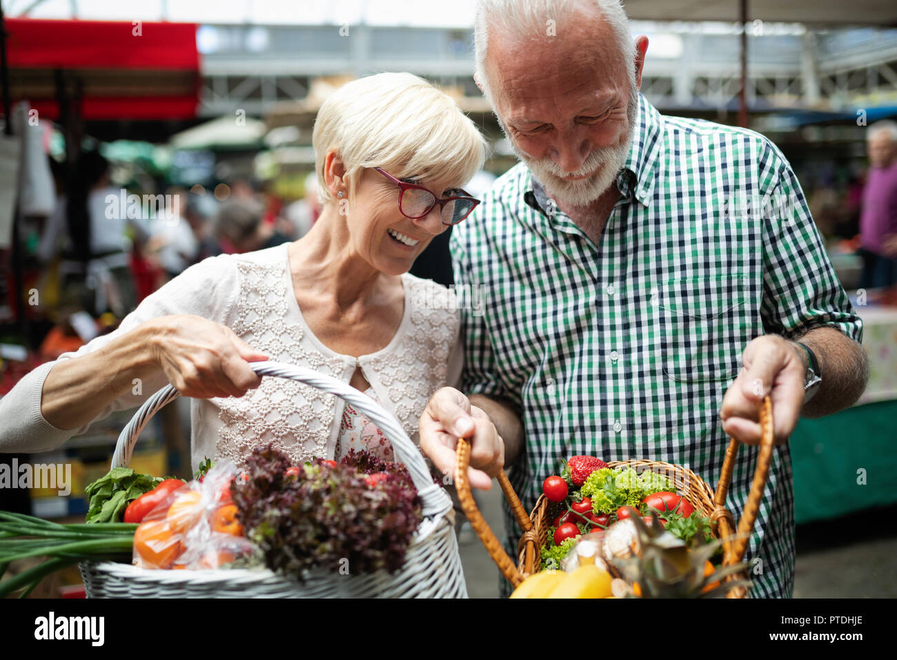 Only the best fruits and vegetables. Beautiful senior couple buying ...