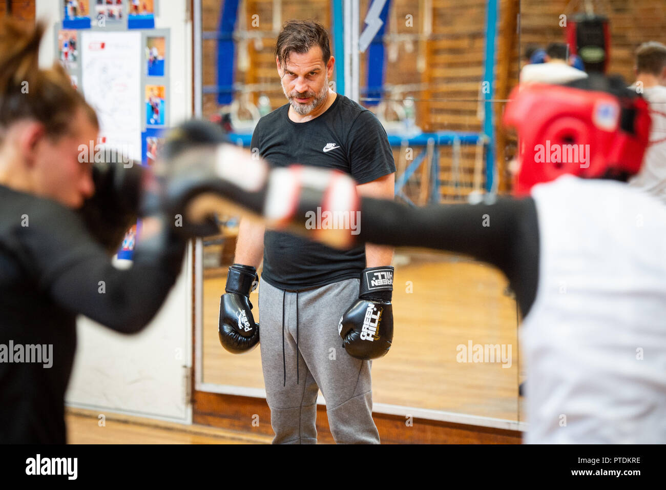 06 October 2018, Berlin: Kay Huste (M), boxing coach, follows the ...