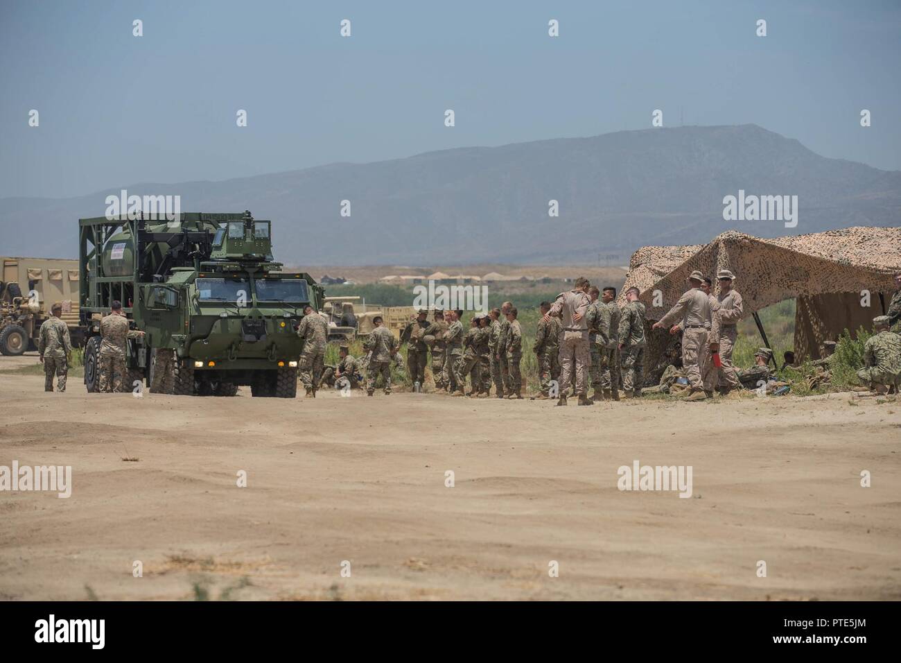 A U.S. Marine Corps AMKR18 logistics vehicle system drives across the ...