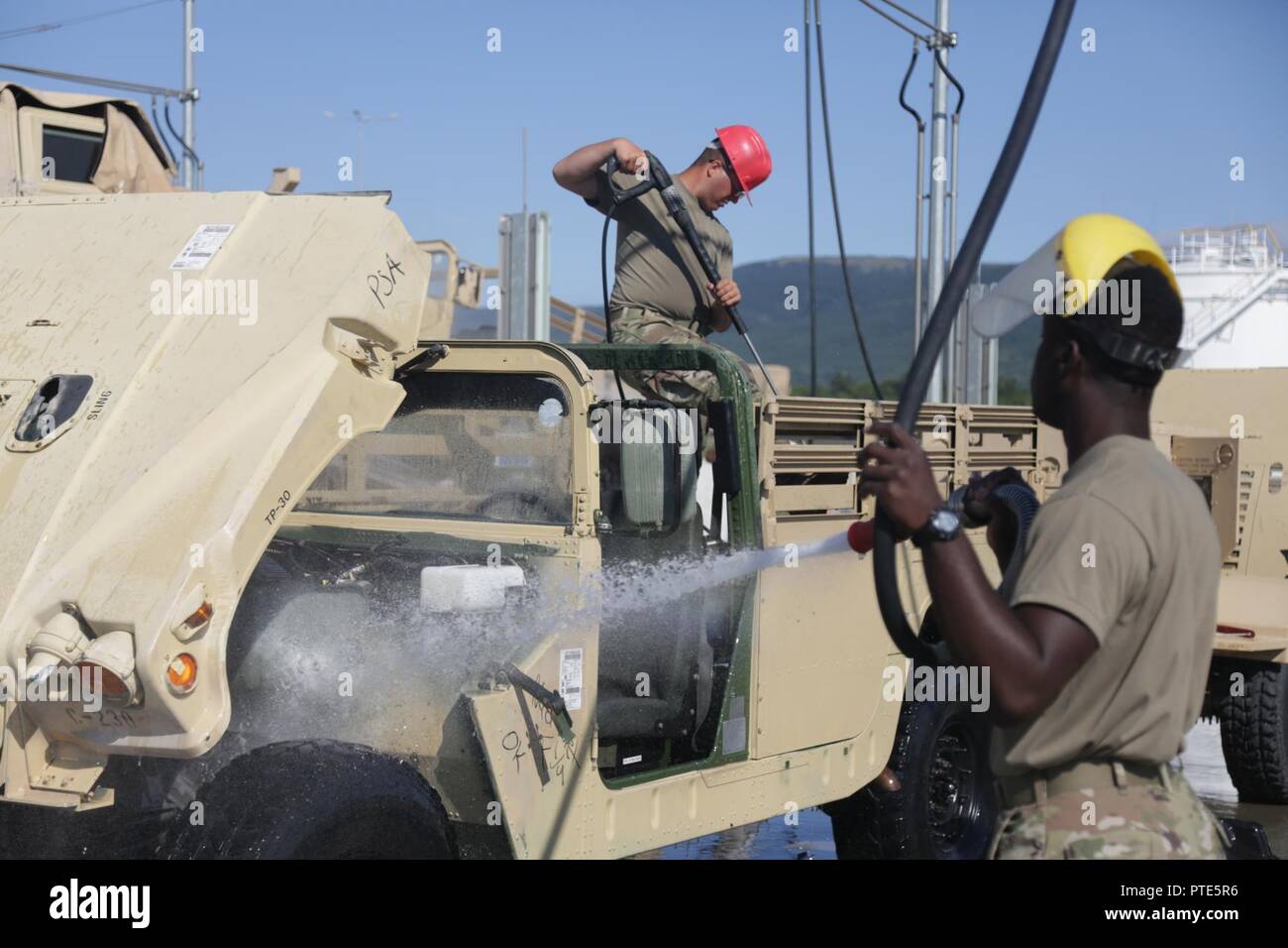 Soldiers from the 86th Expeditionary Signal Battalion wash trucks and ...