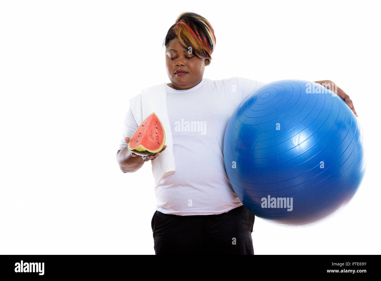 Studio shot of fat black African woman holding exercise ball and Stock ...