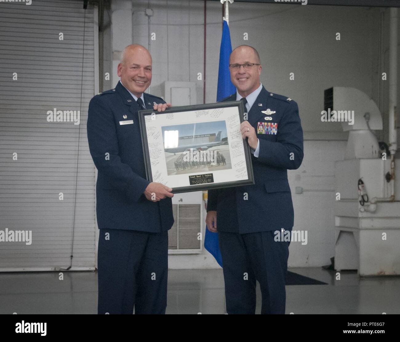 Col. James Locke presents Col. Yenchesky a farewell gift at a change of ...
