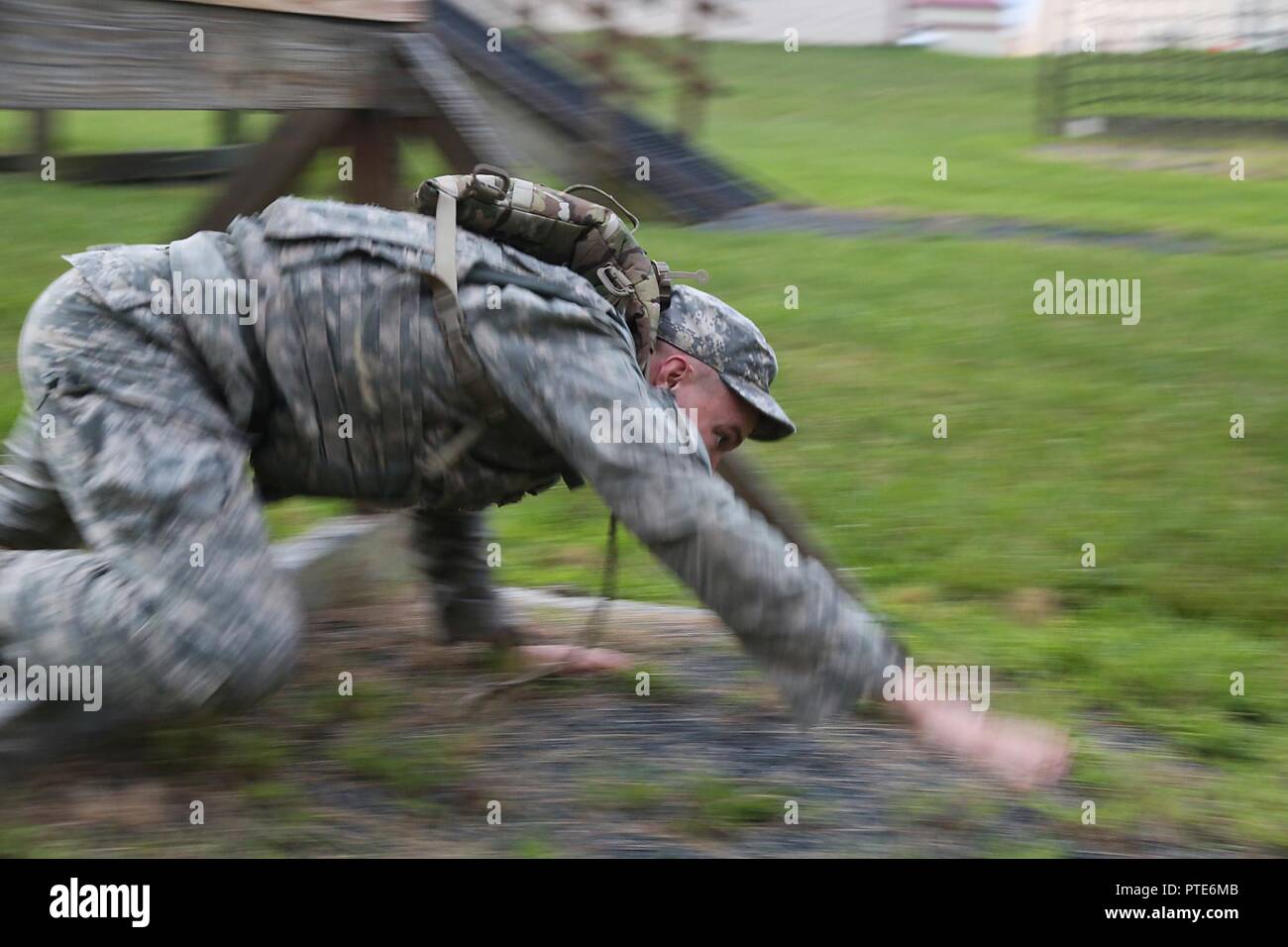 U.S. Army Spc. Thomas Keearns, 48th Chemical Brigade, crawls under an ...