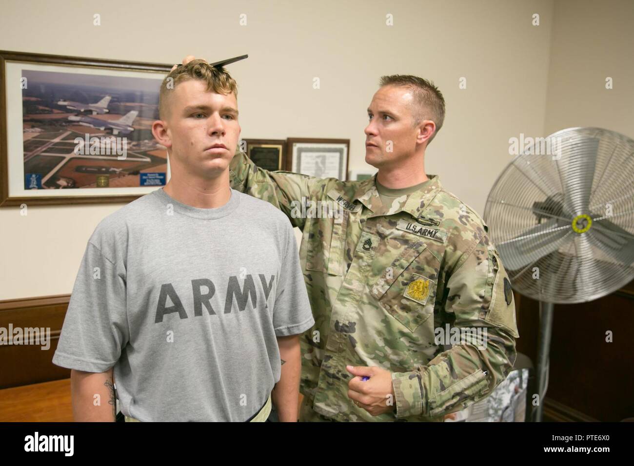 U.S. Army Sgt. 1st Class Joshua Weaver measures height and weight on ...