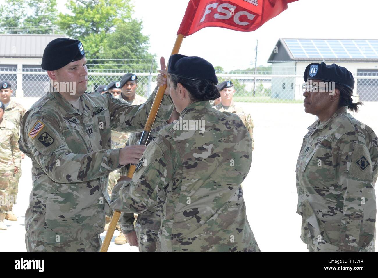 Incoming Commander CPT Dylan Knehr accepts the guidon from LTC Esther ...