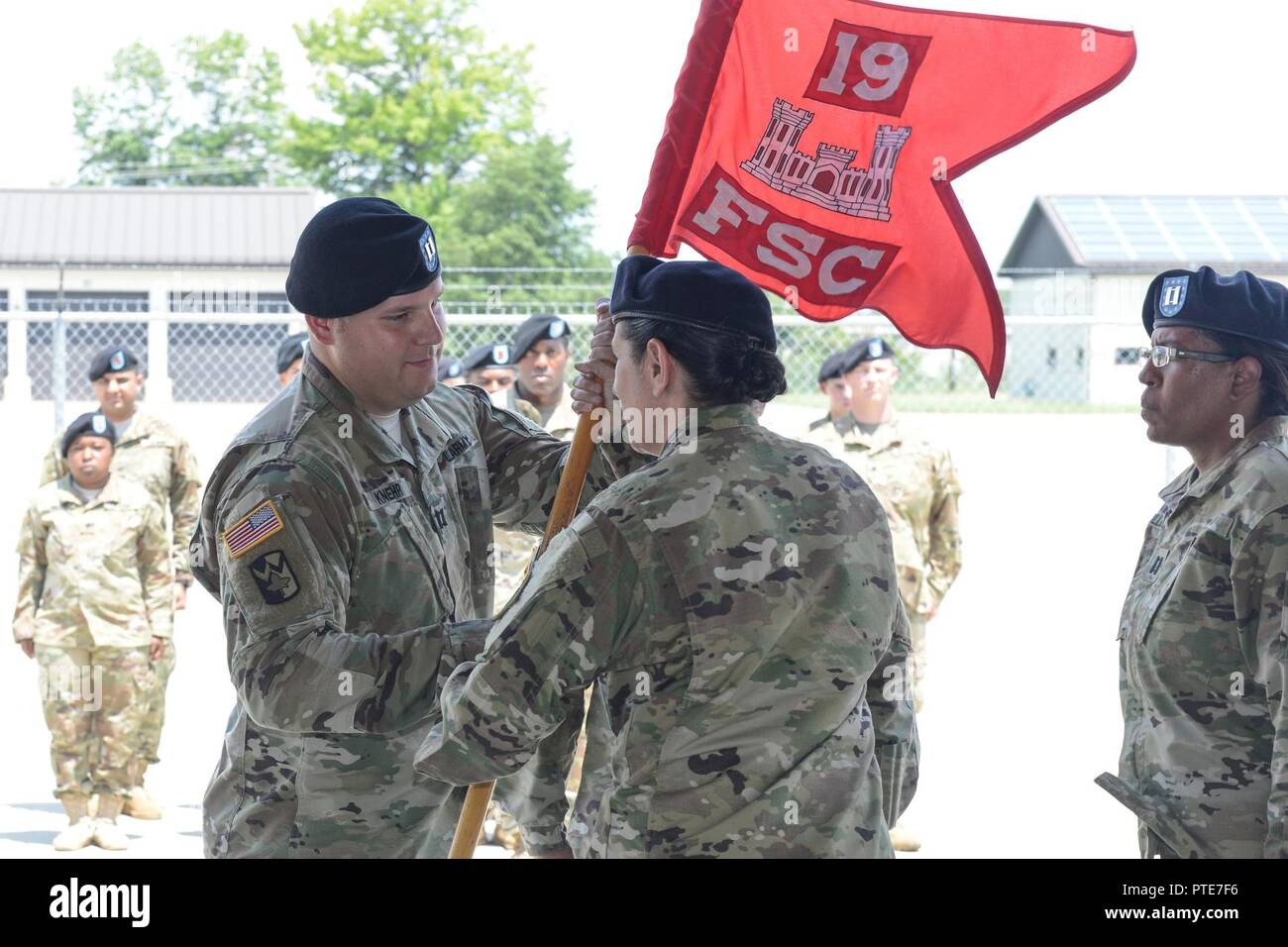 Incoming Commander CPT Dylan Knehr accepts the guidon from LTC Esther ...