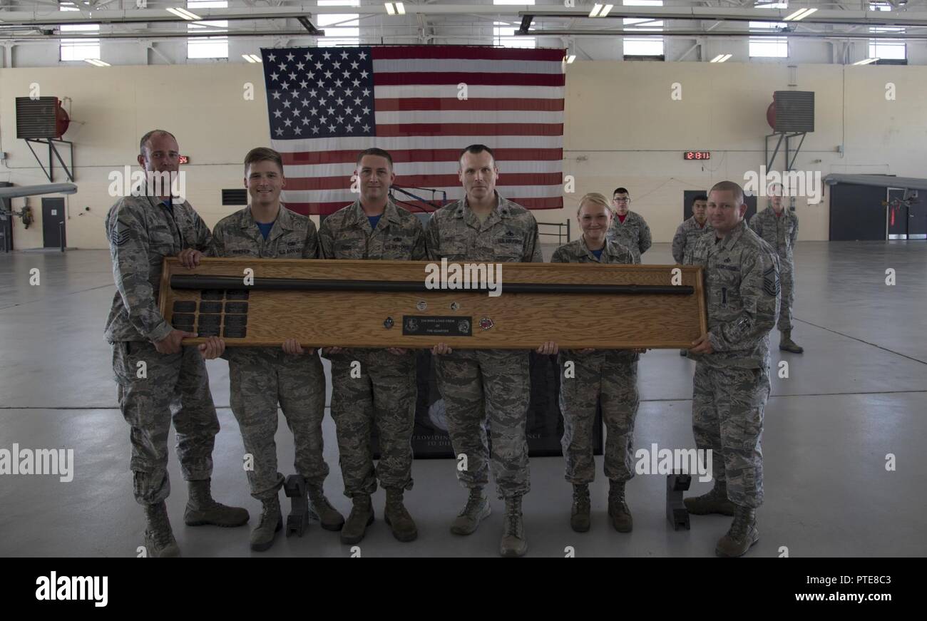 Members of the 74th Aircraft Maintenance Unit hold up the Load Crew of ...