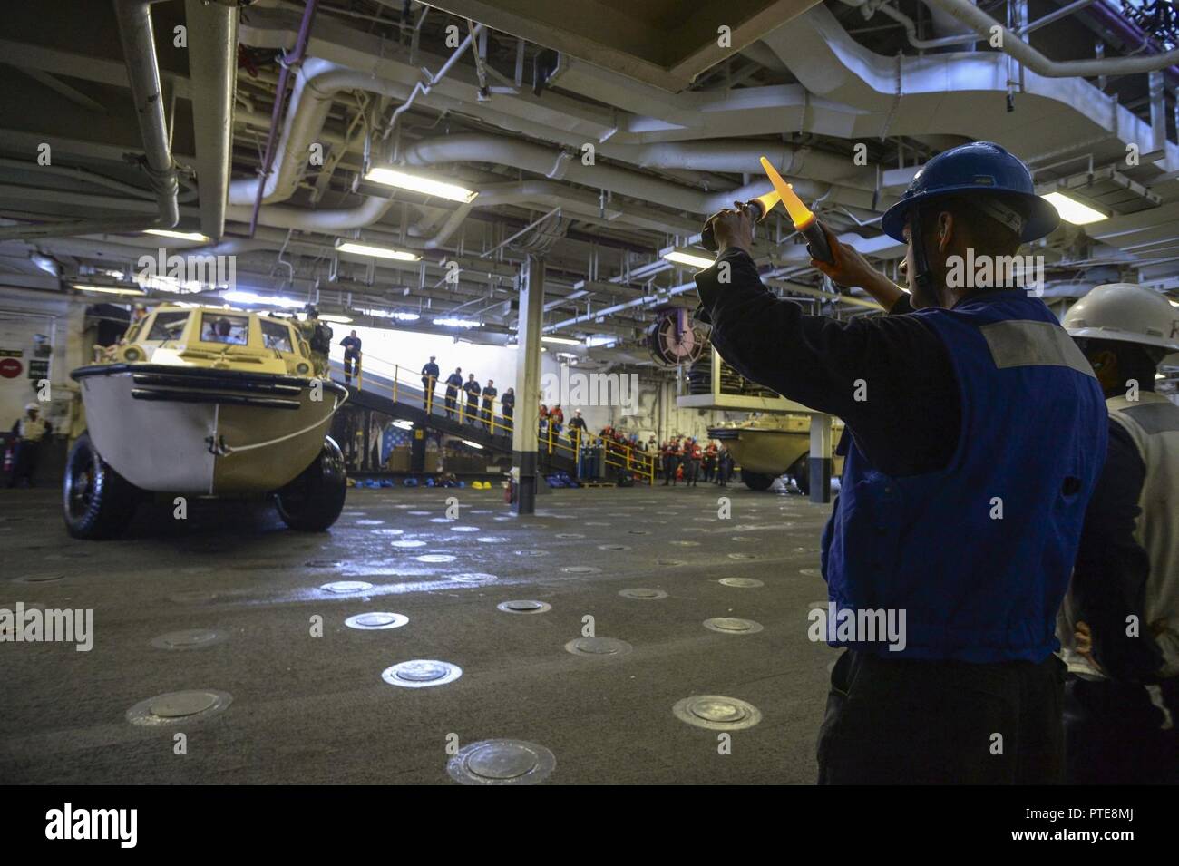 OCEAN (July 14, 2017) Seaman Matthew Freeman directs a light amphibious ...