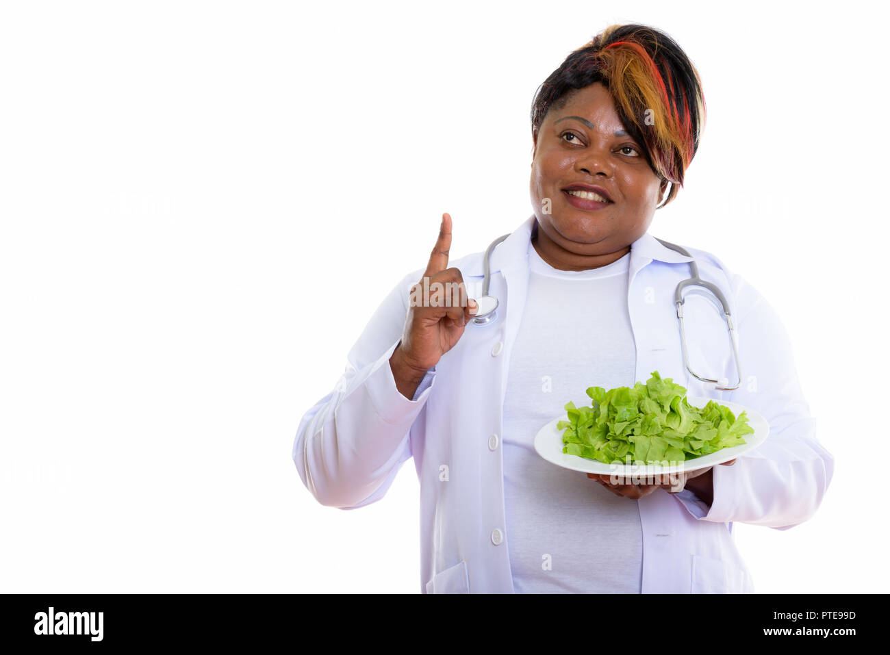 Thoughtful happy fat black African woman doctor smiling while ho Stock ...