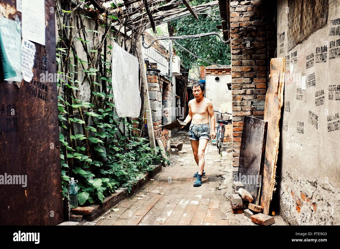 Beijing / China - JUN 24 2011: man cleaning the street outside of his ...