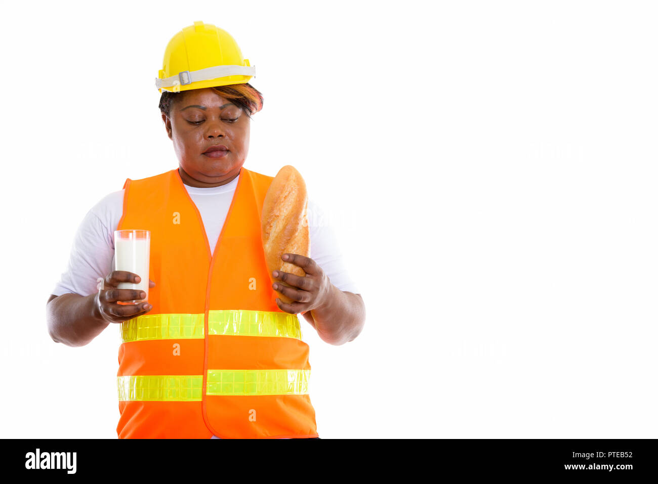 Studio shot of fat black African woman construction worker holdi Stock ...