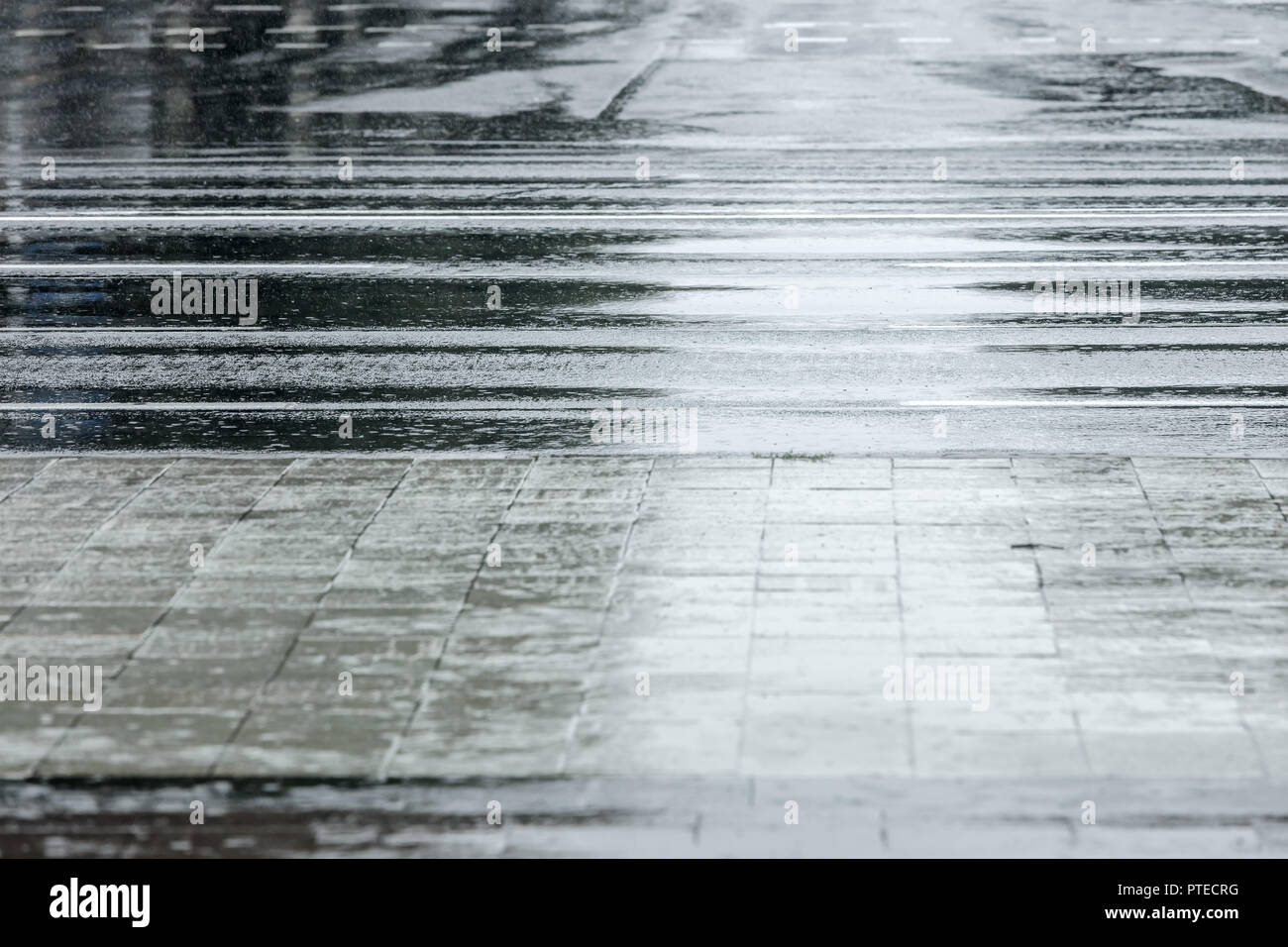 wet pavement and asphalt road during rainy weather Stock Photo - Alamy