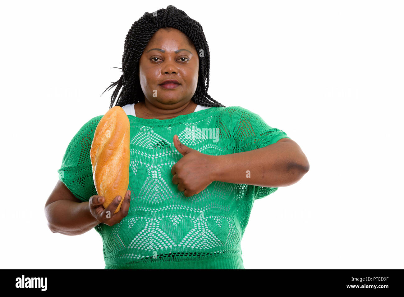 Studio shot of fat black African woman holding bread and giving Stock ...