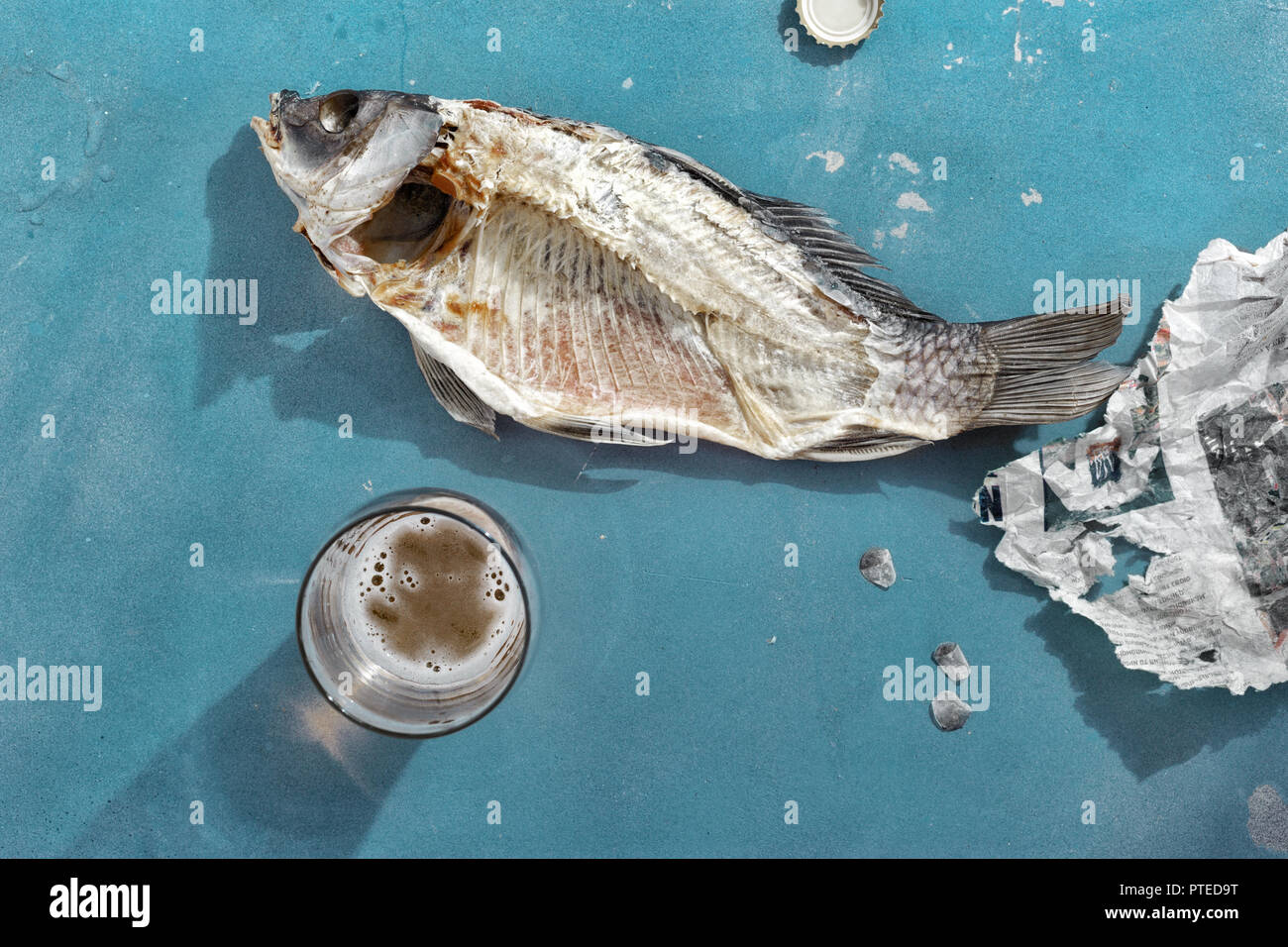 Dried fish with beer on stone blue background top view Stock Photo - Alamy