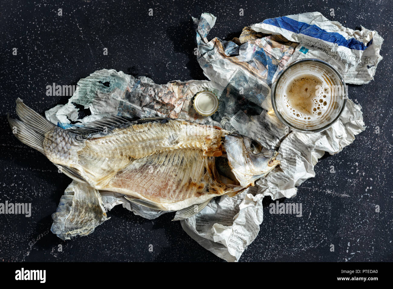 Dried fish with beer on dark blue background top view Stock Photo - Alamy