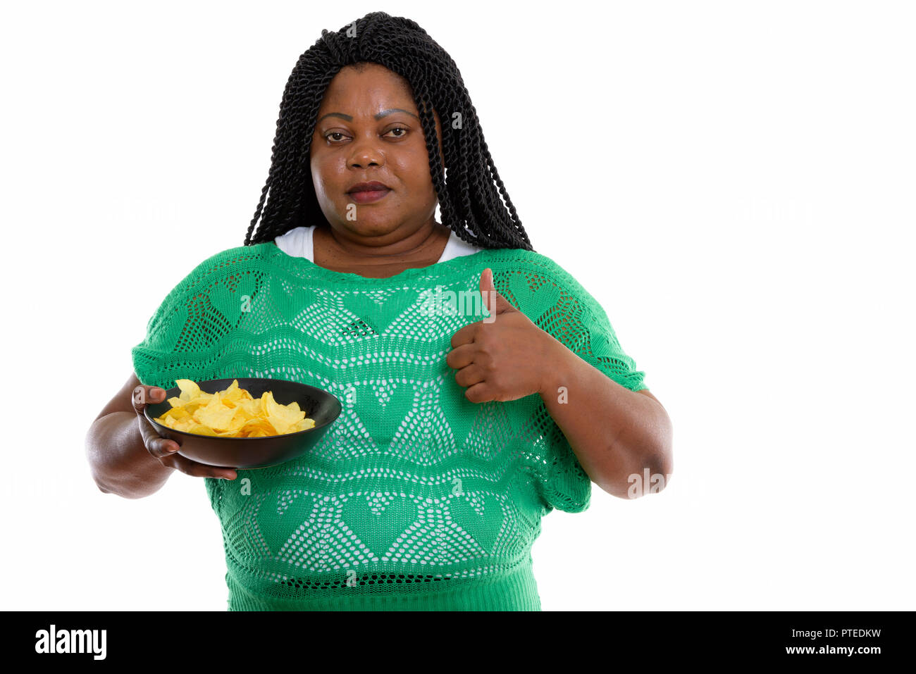 Studio shot of fat black African woman holding bowl of potato ch Stock ...