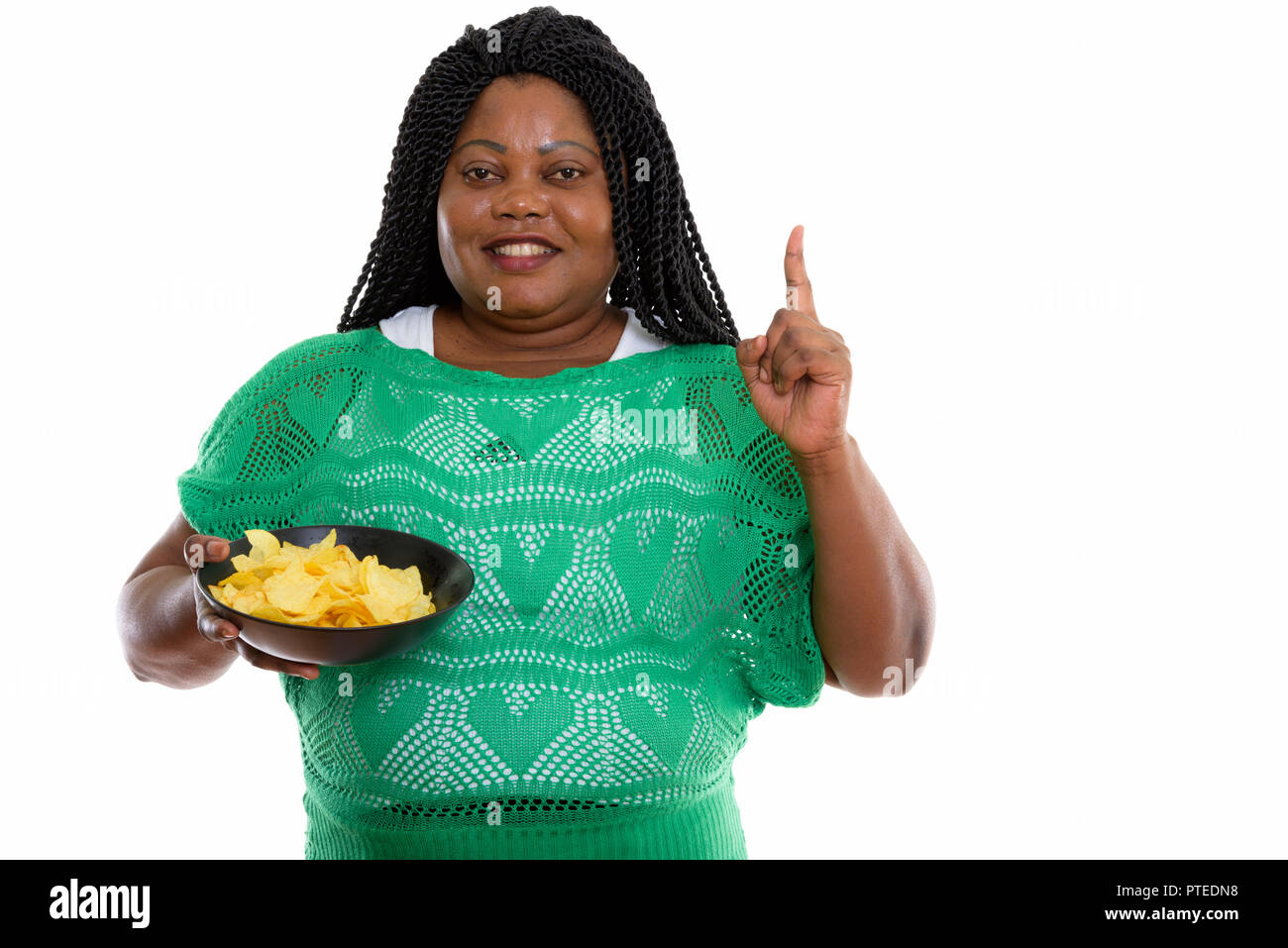 Studio shot of happy fat black African woman smiling while holdi Stock ...
