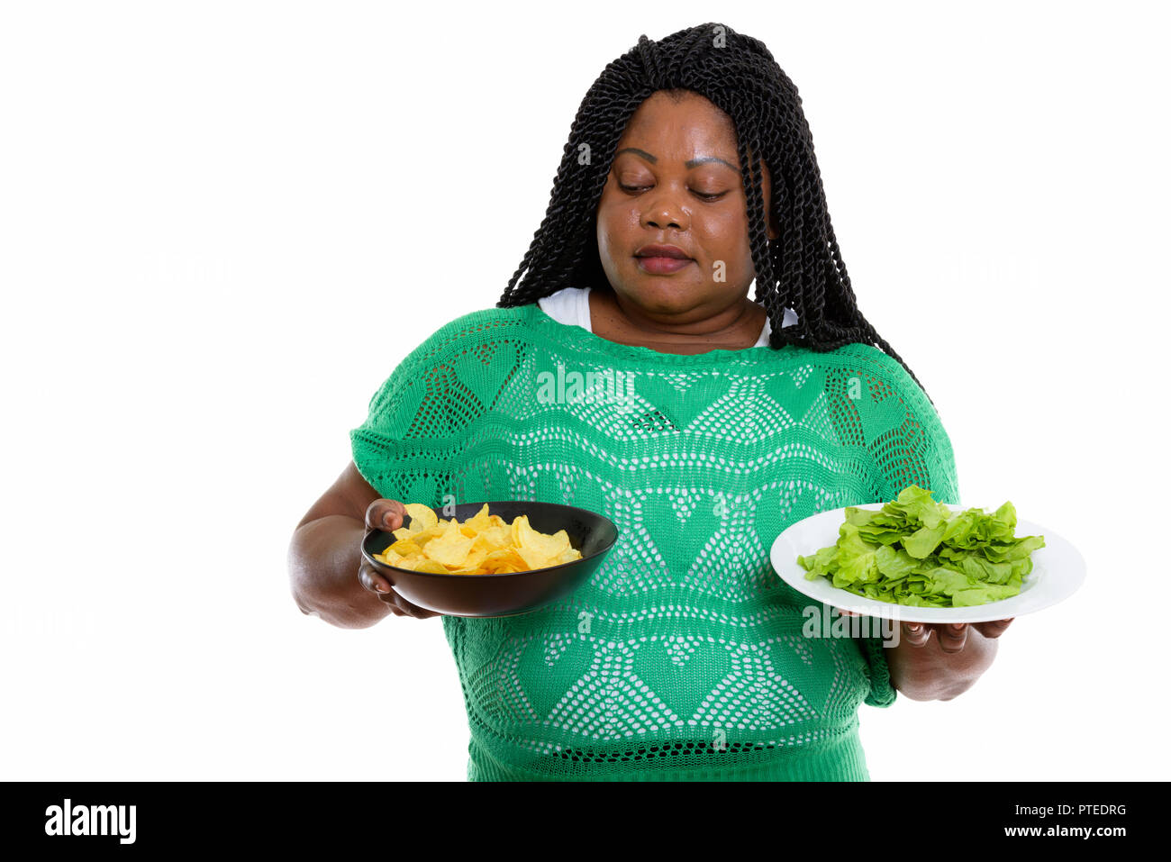 Studio shot of fat black African woman looking at bowl of potato Stock ...